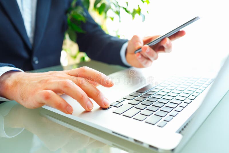 Men Office Worker Typing on the Keyboard and Using Smartphone Stock ...