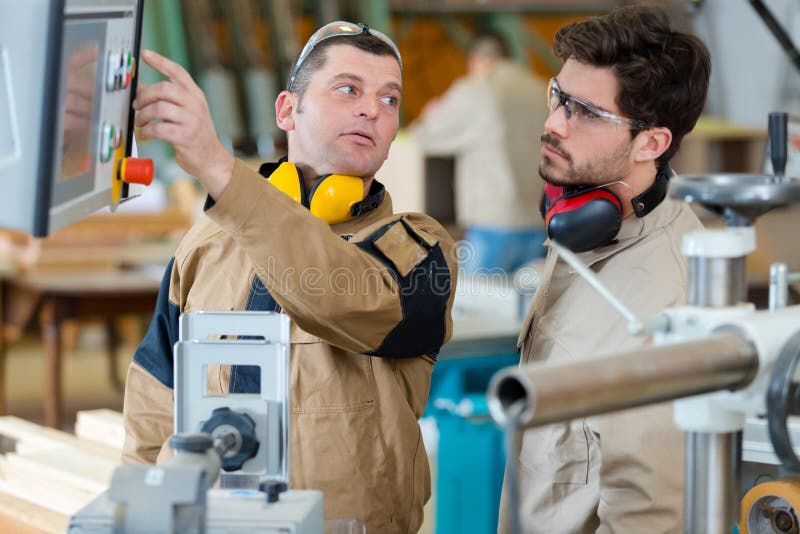 Men Operating Machines in Factory Stock Photo - Image of manual ...