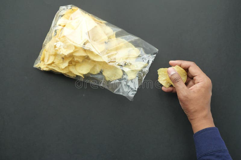 Men Pick Potato Chips from a Plastic Packet Stock Photo - Image of ...