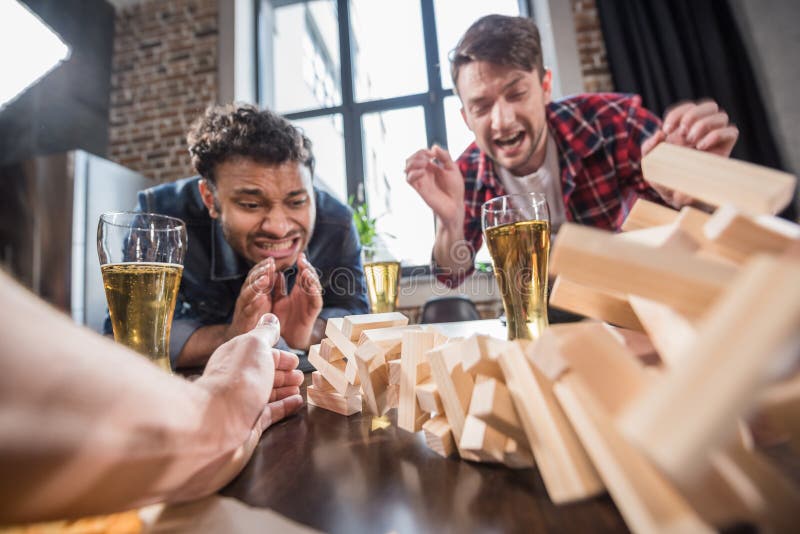 Men playing jenga game stock image. Image of playing - 93099863