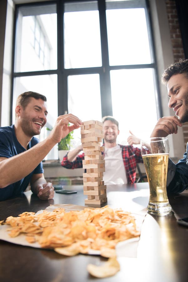 Men playing jenga game stock image. Image of competition - 93099735