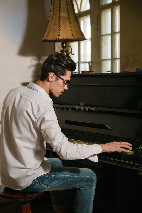 The men playing the piano stock image. Image of concert - 75676533