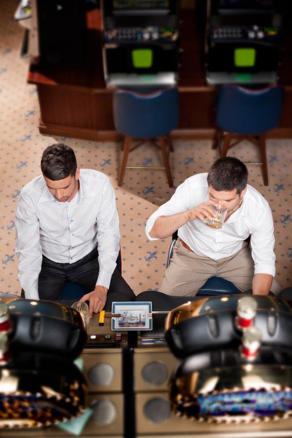 Men Playing the Slot Machine Stock Image - Image of businessman ...