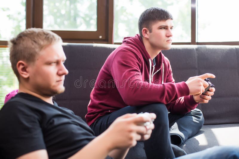 Men Playing Video Games while Sitting on Sofa Stock Image - Image of ...