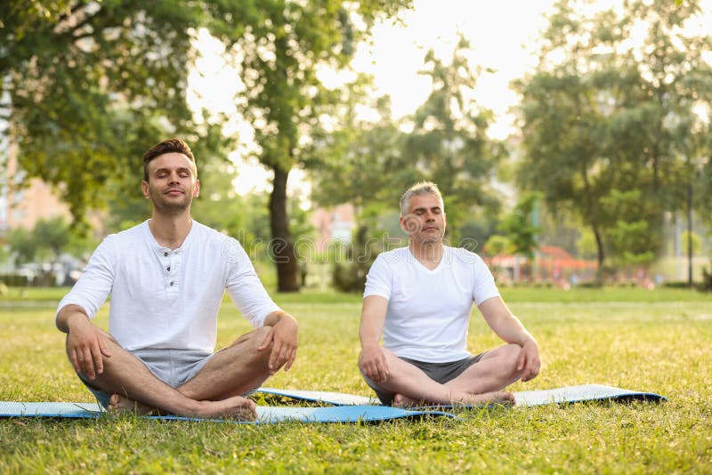 Men Practicing Yoga at Morning Stock Photo - Image of concentration ...
