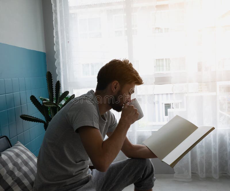 Men Read Books with Coffee Mugs in the Living Room Stock Photo - Image ...