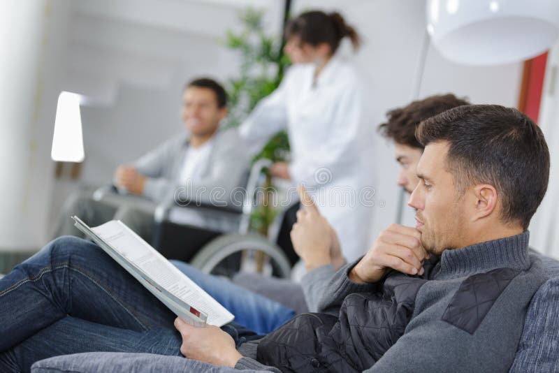 Men Reading in Hospital Waiting Room Stock Photo - Image of reading ...
