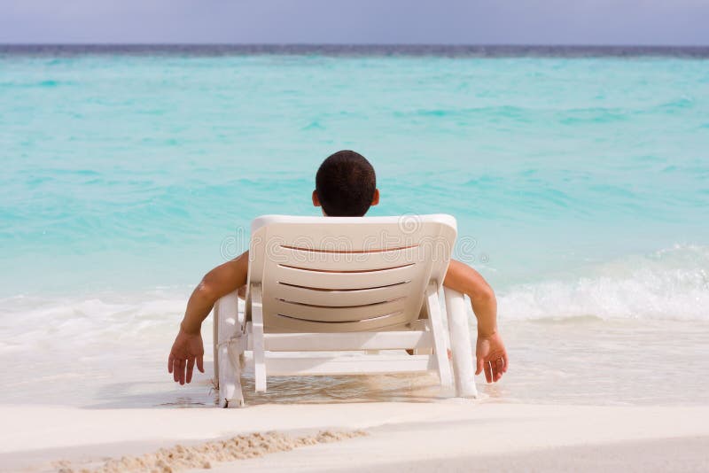 Man relaxing on beach stock image. Image of male, relaxation - 45240799