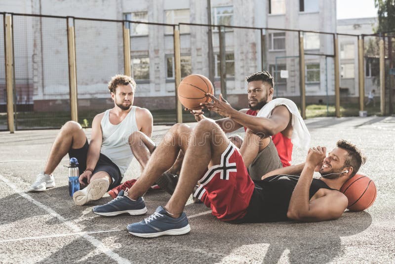 Men Resting after Basketball Game on Court Stock Photo - Image of ...