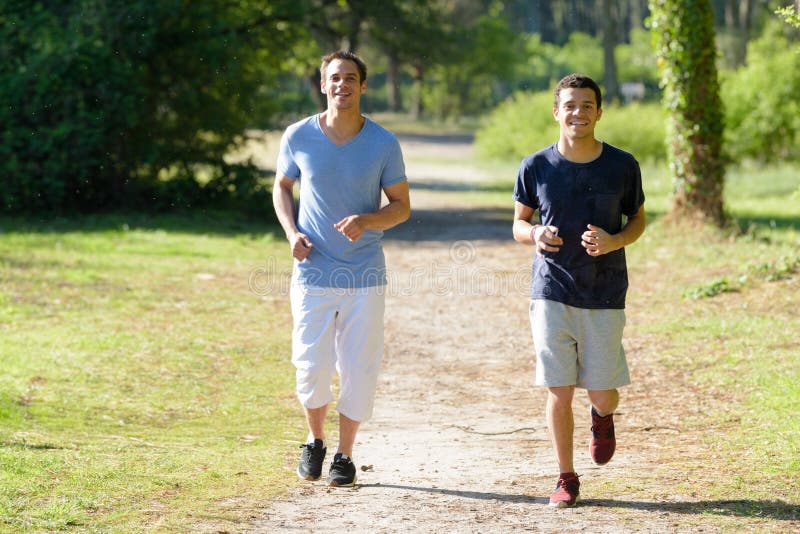 Men running forest trail stock image. Image of motion - 262851611
