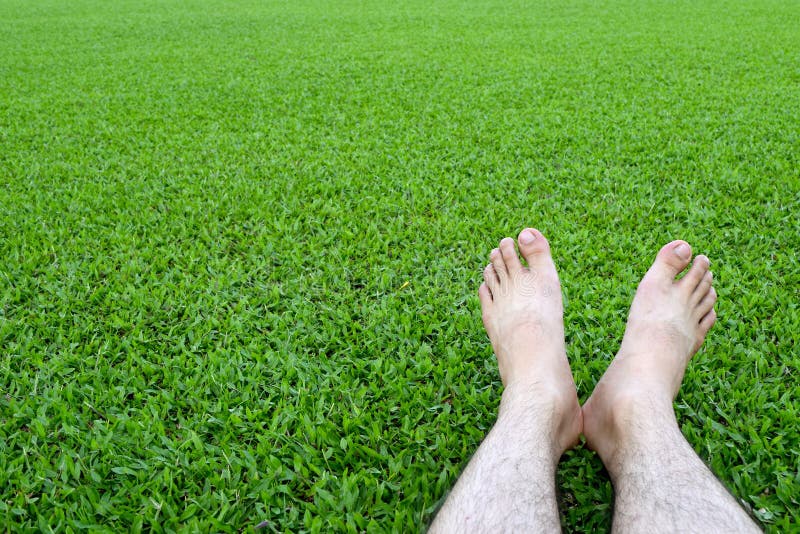 Men S Feet on the Background of Lush Green Grass Stock Image - Image of ...