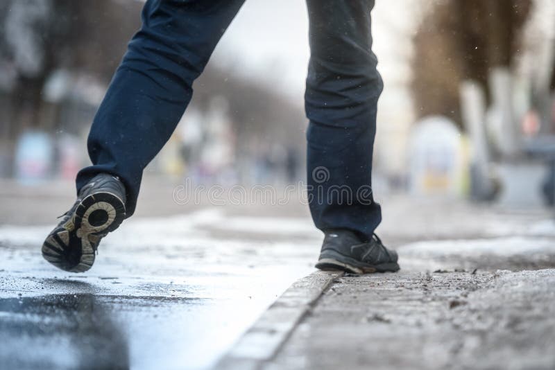 Men`s Feet Step Over a Puddle of Spring in the City Stock Image - Image ...