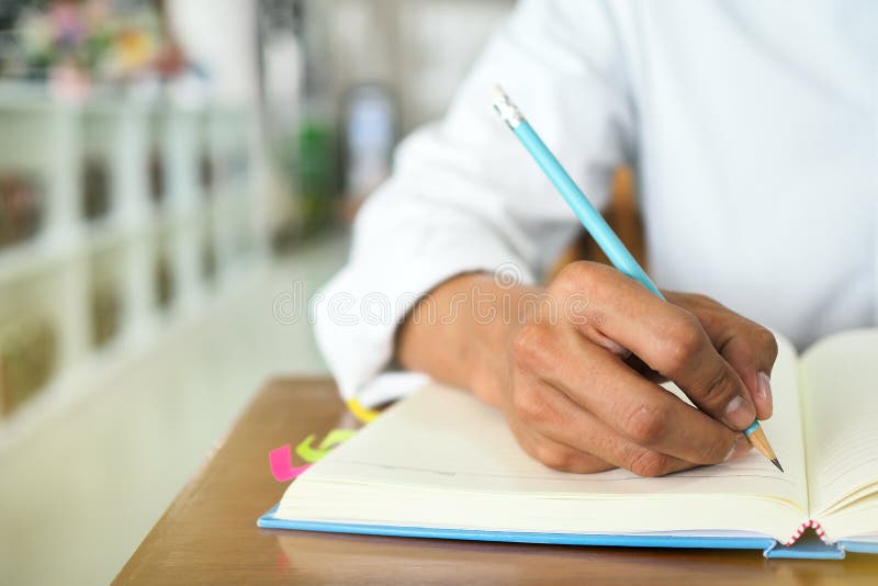 Men Hand is Writing a Book. Sit in the Library Stock Photo - Image of ...