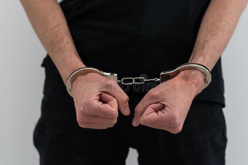 Men& X27;s Hands Closed in Chrome Handcuffs Stock Photo - Image of ...