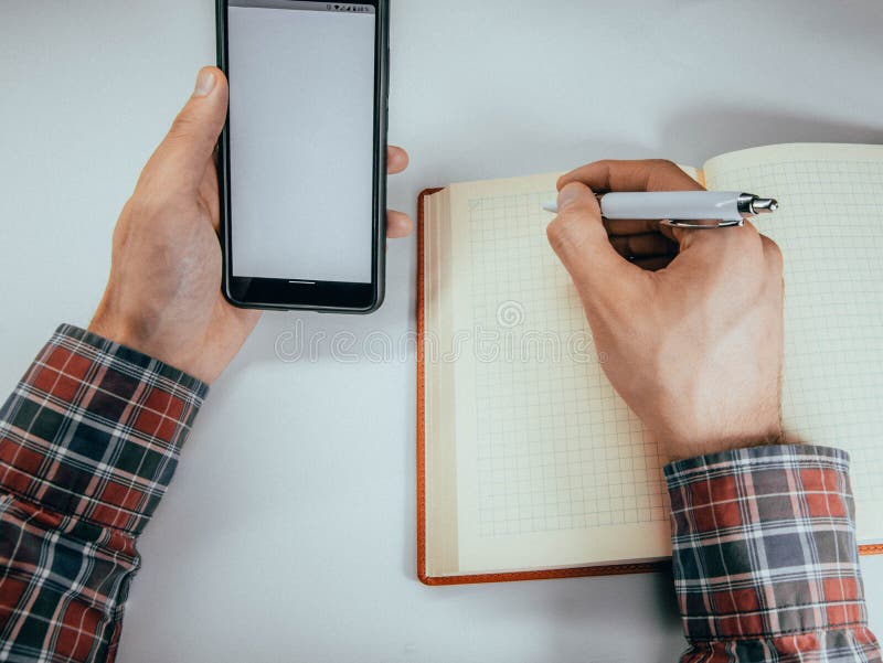 Men`s Hands, Forearm Hold a Pen, Notebook, Smartphone. Hands Write in ...