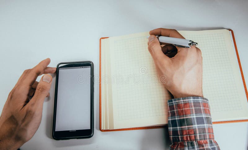 Men`s Hands, Forearm Hold a Pen, Notebook, Smartphone. Hands Write in ...