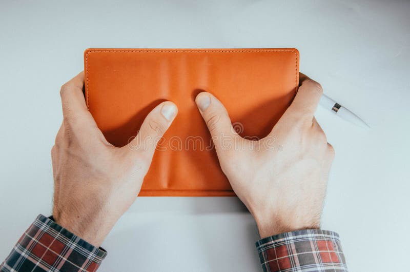 Men`s Hands, Forearm Hold a Pen, Notebook, Smartphone. Hands Write in ...