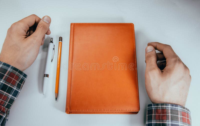Men`s Hands, Forearm Hold a Pen, Notebook, Smartphone. Hands Write in ...