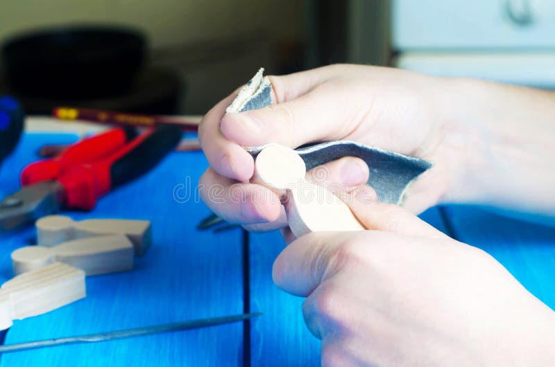 The Master Processes the Wood with His Hands. Working Hands on a Blue ...