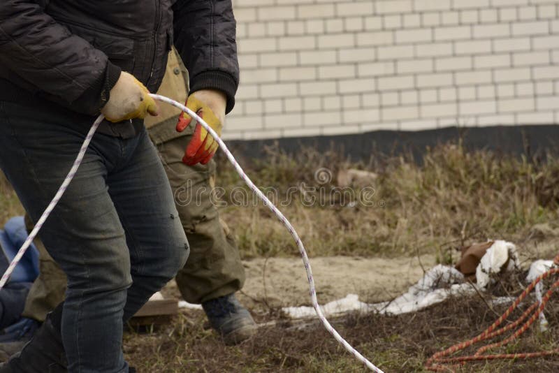Men`s Hands in Work Gloves Pull the Rope. Stock Image - Image of ...