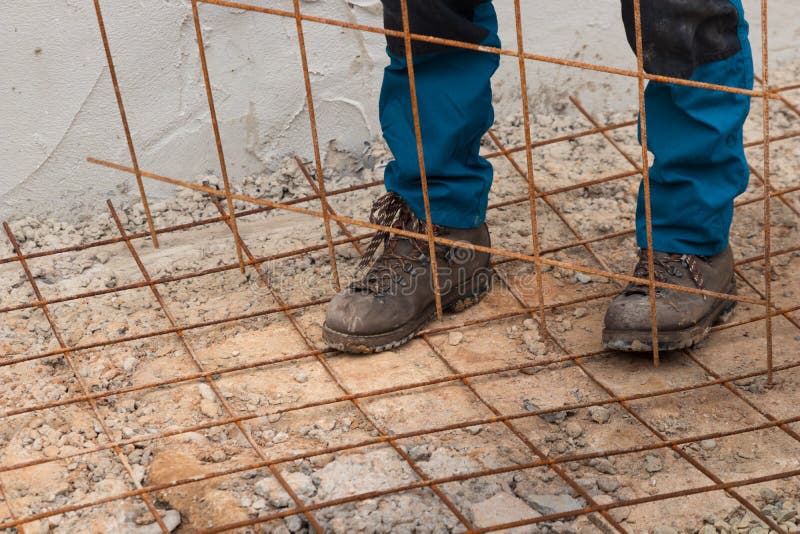 Men S Legs Working on the Construction with Rusty Wire Mesh on the ...