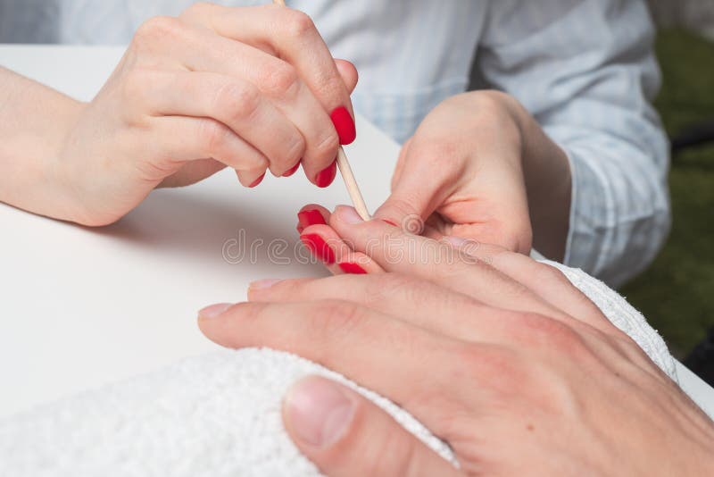 Men`s Manicure. the Hands of the Beautician Treated Cuticle of Men`s ...