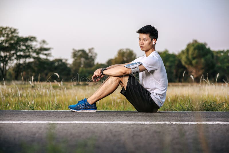 Men Sitting and Resting after Exercising on the Roadside Stock Photo ...