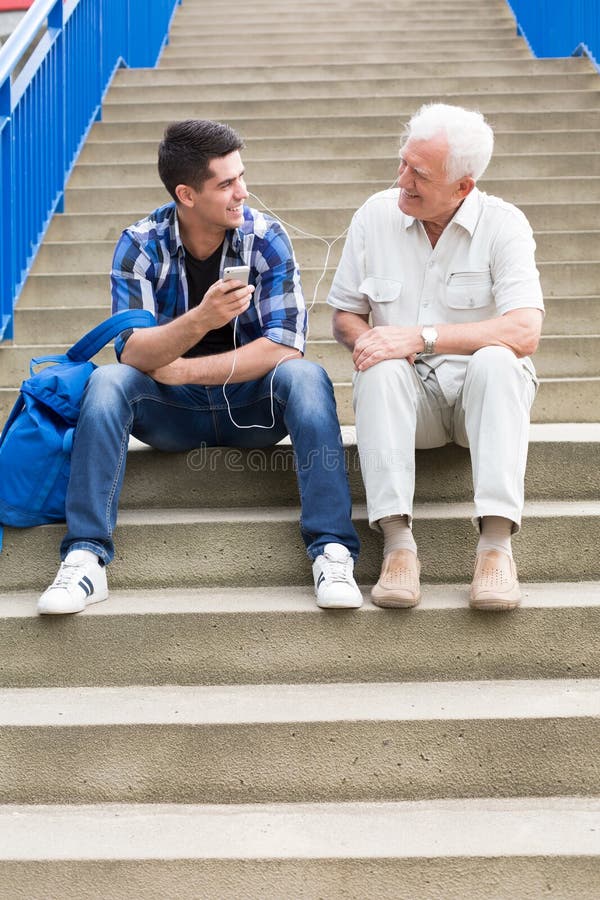 Men sitting on stairs stock image. Image of cheerful - 69944545