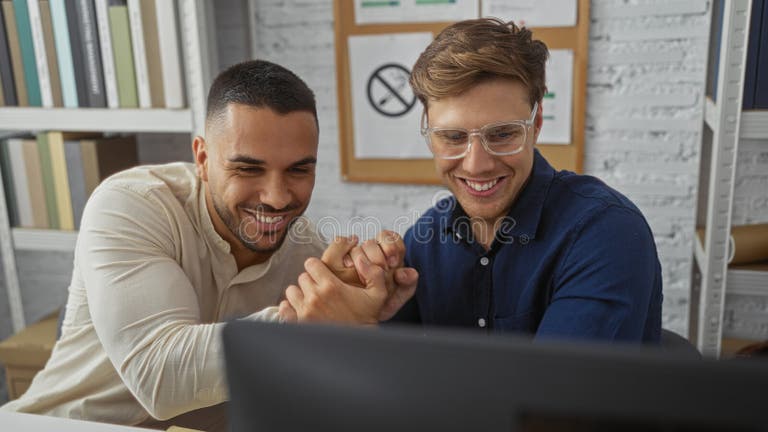 Men Smiling in an Office, Collaborating on a Computer, Showcasing a Successful Partnership and ...