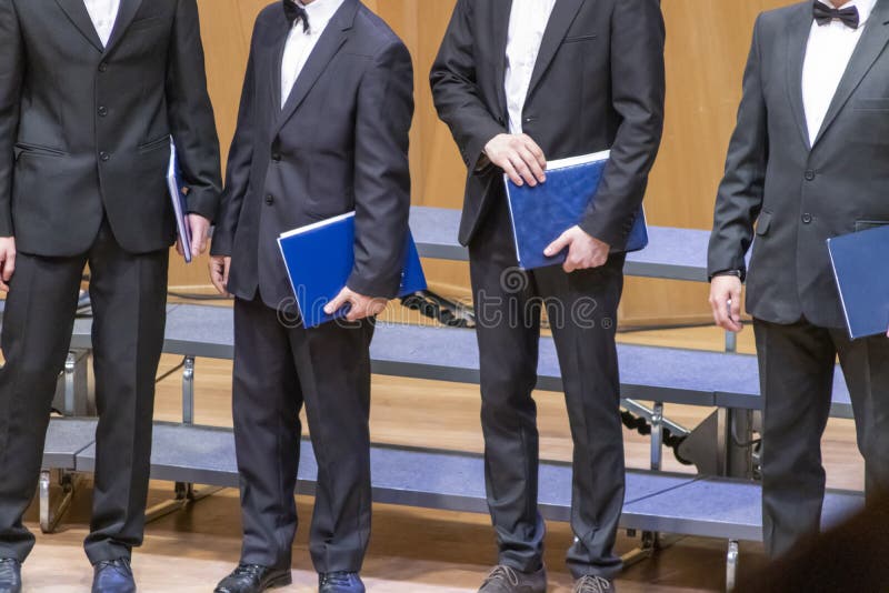 Men Stand in Black Suits with Blue Folders Stock Image - Image of white ...