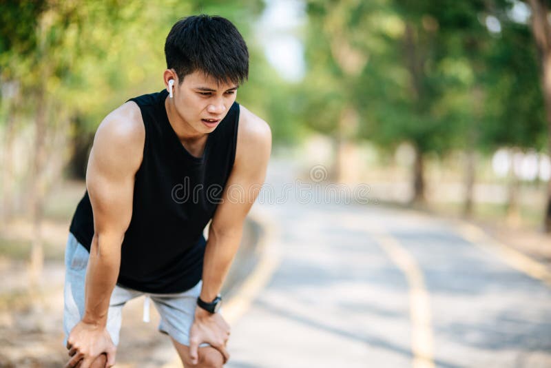 Men Stand and Bow and Rest after Exercising on the Roadside Stock Image ...
