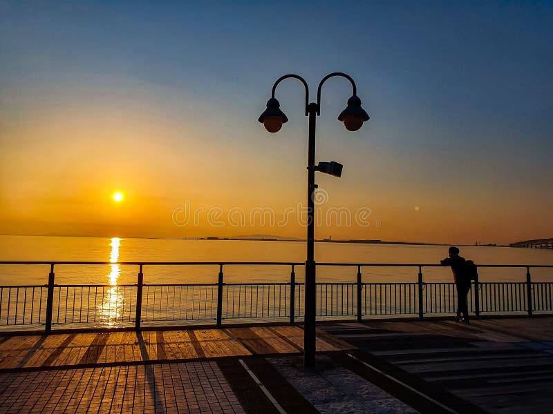 A Men Standing Facing the Sunset Stock Photo - Image of lighting, night ...