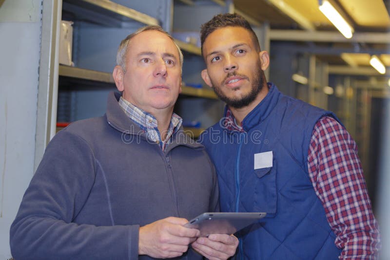 Men Staring at Something Inside Factory Stock Photo - Image of area ...