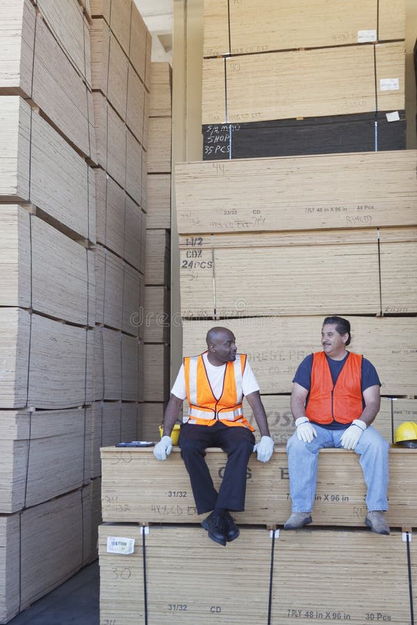 Men Taking Break from Work in Warehouse Stock Photo - Image of sitting ...