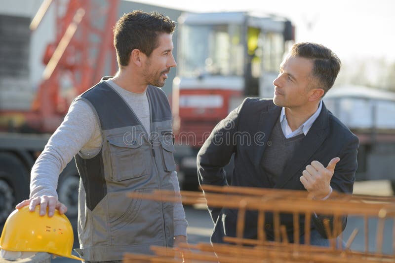 Men Talking on Construction Site Stock Photo - Image of factory, detail ...