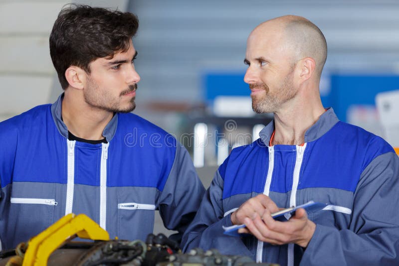 Men Talking while Working in Garage Stock Photo - Image of airport ...