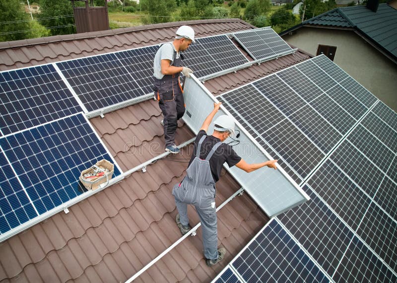 Men Technicians Mounting Photovoltaic Solar Moduls on Roof of House ...