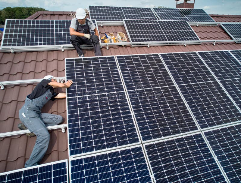 Men Technicians Mounting Photovoltaic Solar Moduls on Roof of House ...
