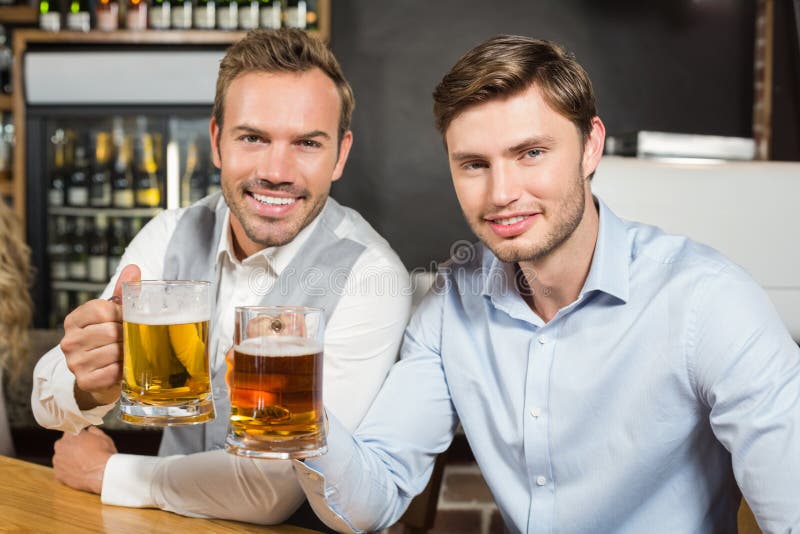 Men toasting with beers stock image. Image of caucasian - 67731523