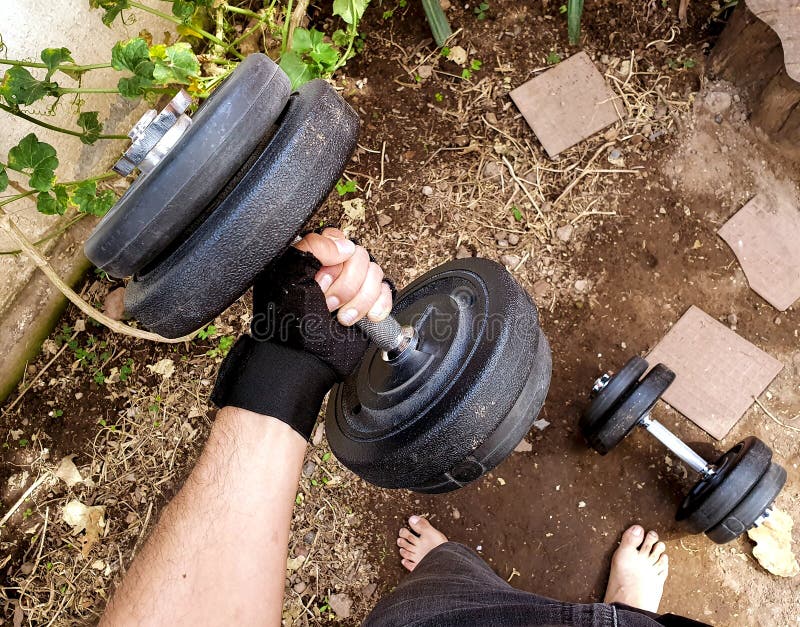 Pair of Dumbbells in Front of Men Foot, Exercise Concept Stock Image ...