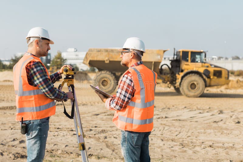 Worker and Construction Manager Consulting on a Project with Eng Stock ...