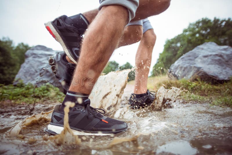 Men Walking in Muddy Puddles Stock Image - Image of adult, outdoors ...