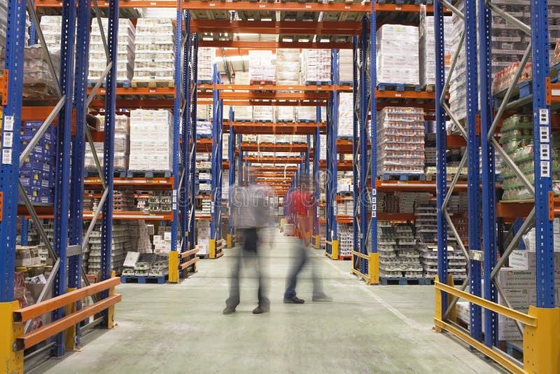 Men Walking in Warehouse stock photo. Image of rack, large - 31841618
