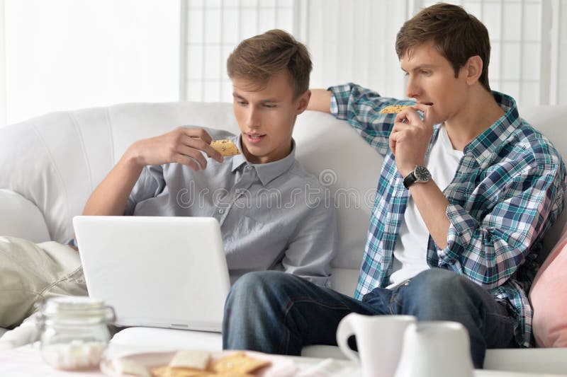Men Watching Video on Laptop Stock Image - Image of people, table: 82507209