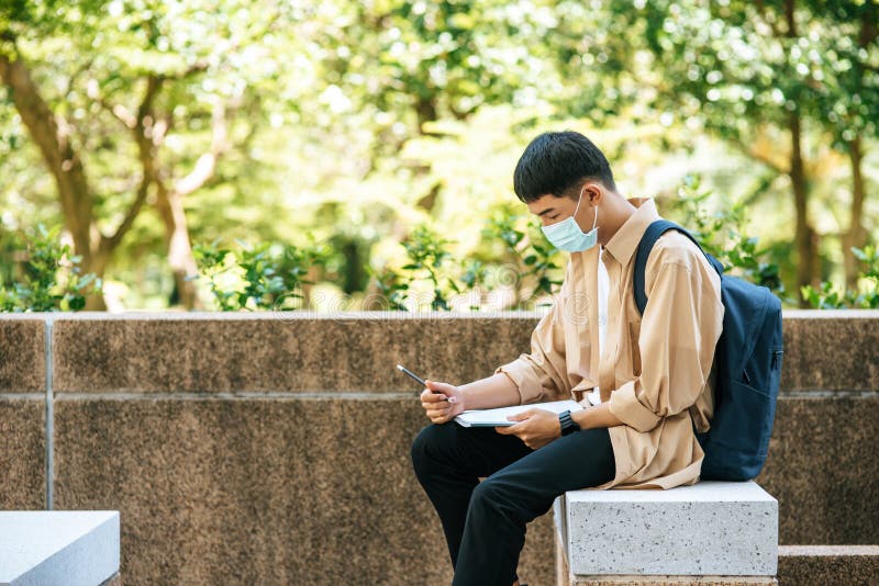 Men Wearing Masks Sit Reading Books on the Stairs Stock Photo - Image ...