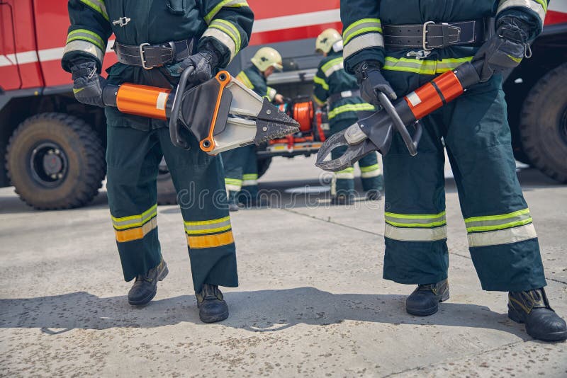Firefighters Holding Ladder Stock Image - Image of close, colour: 5025133