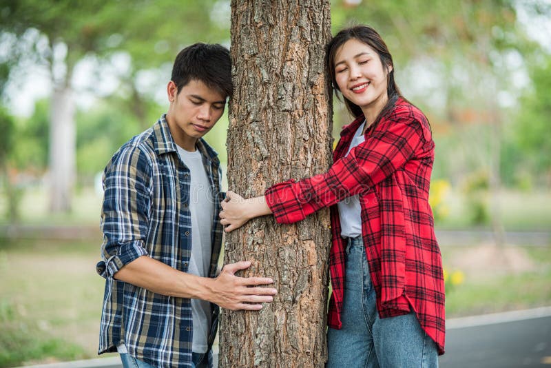 Men and Women Standing and Hugging Trees Stock Image - Image of ...