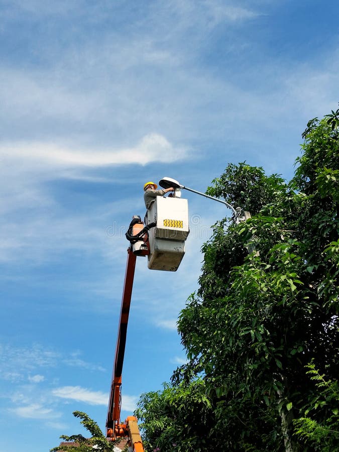 Men at Work, Fix Lamp Light on the Road. Editorial Stock Image - Image ...