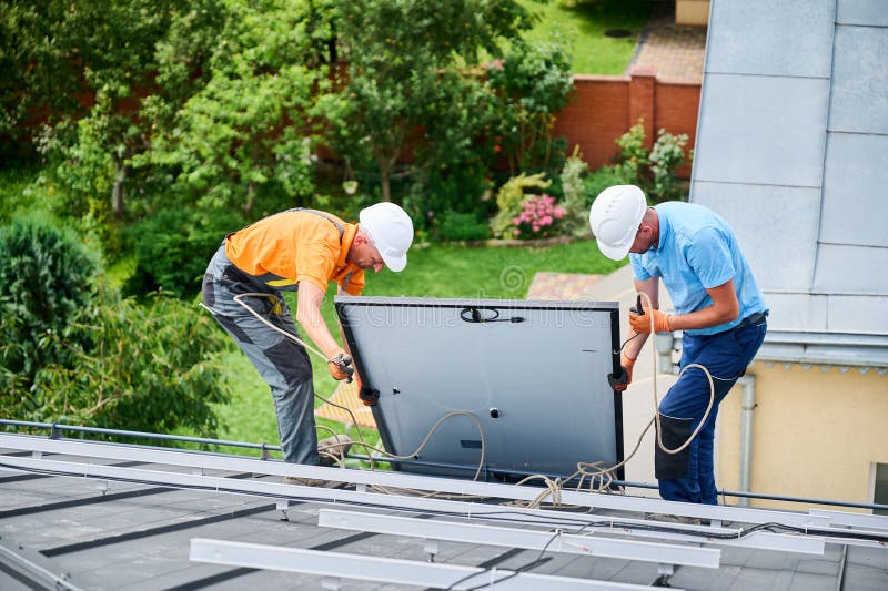 Technicians Carrying Photovoltaic Solar Module while Installing Solar ...
