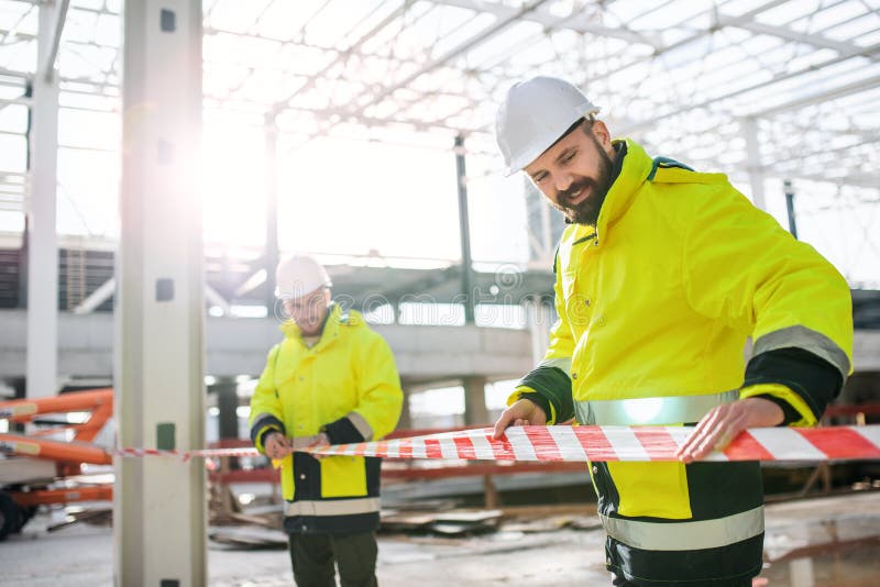 Men Workers Standing Outdoors on Construction Site, Working. Stock ...